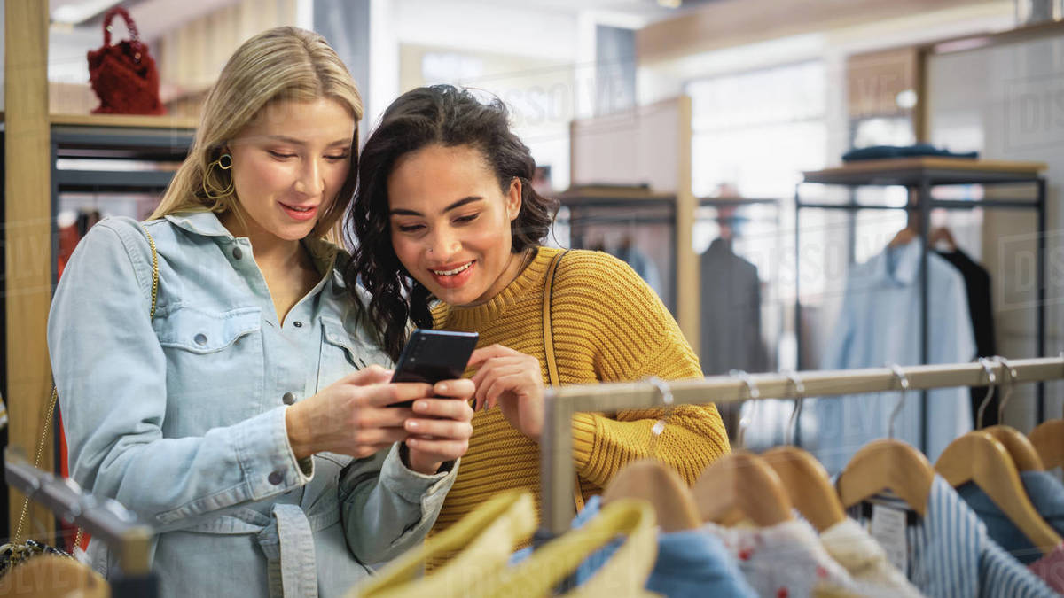Two Beautiful Female Friends Shopping in Clothing Store - Royalty-free ...