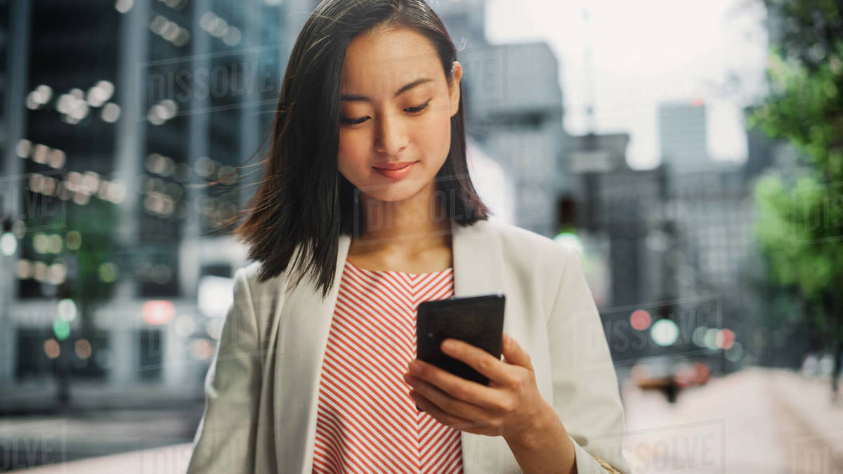 Portrait of a Japanese Female Wearing Smart Casual Clothes and Using ...