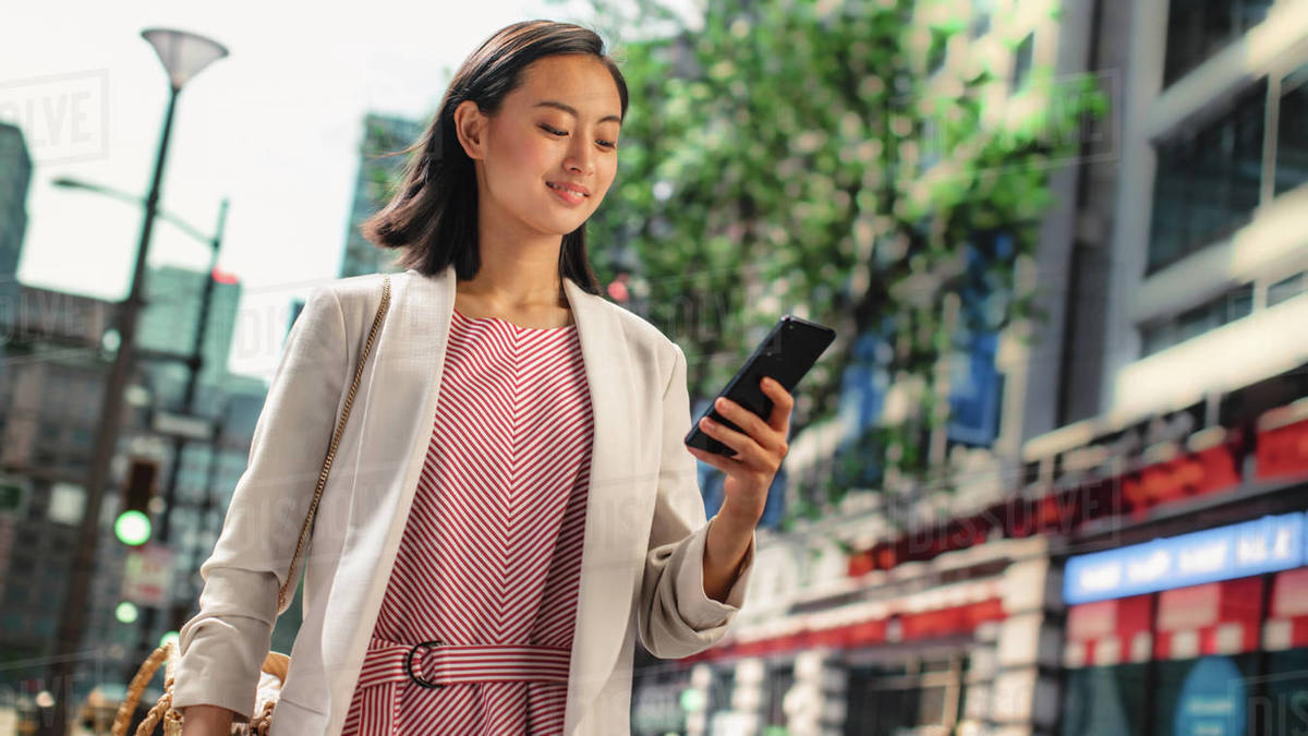 Portrait of a Japanese Female Wearing Smart Casual Clothes and Using ...