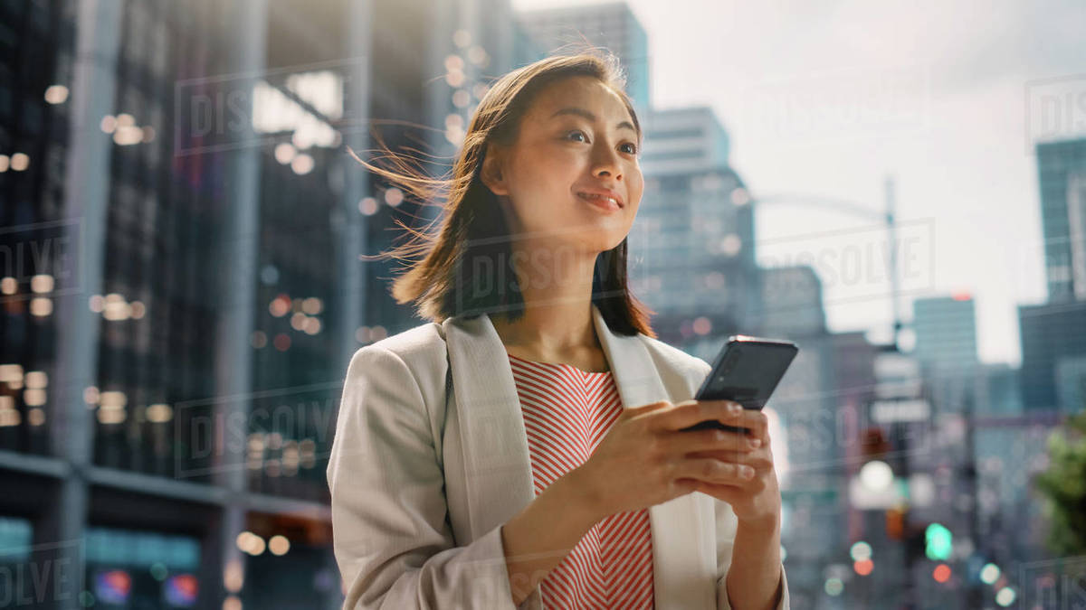 Portrait of a Japanese Female Wearing Smart Casual Clothes and Using ...