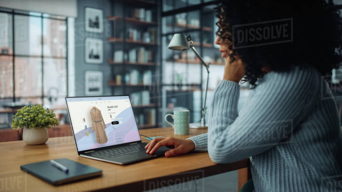 Back View Shot of a Young Female Using Laptop Computer with Clothing ...