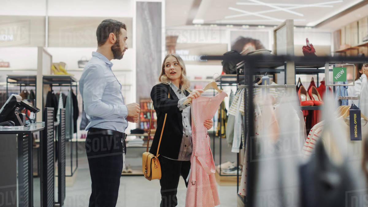Female Customer Shopping in Clothing Store - Stock Photo - Dissolve