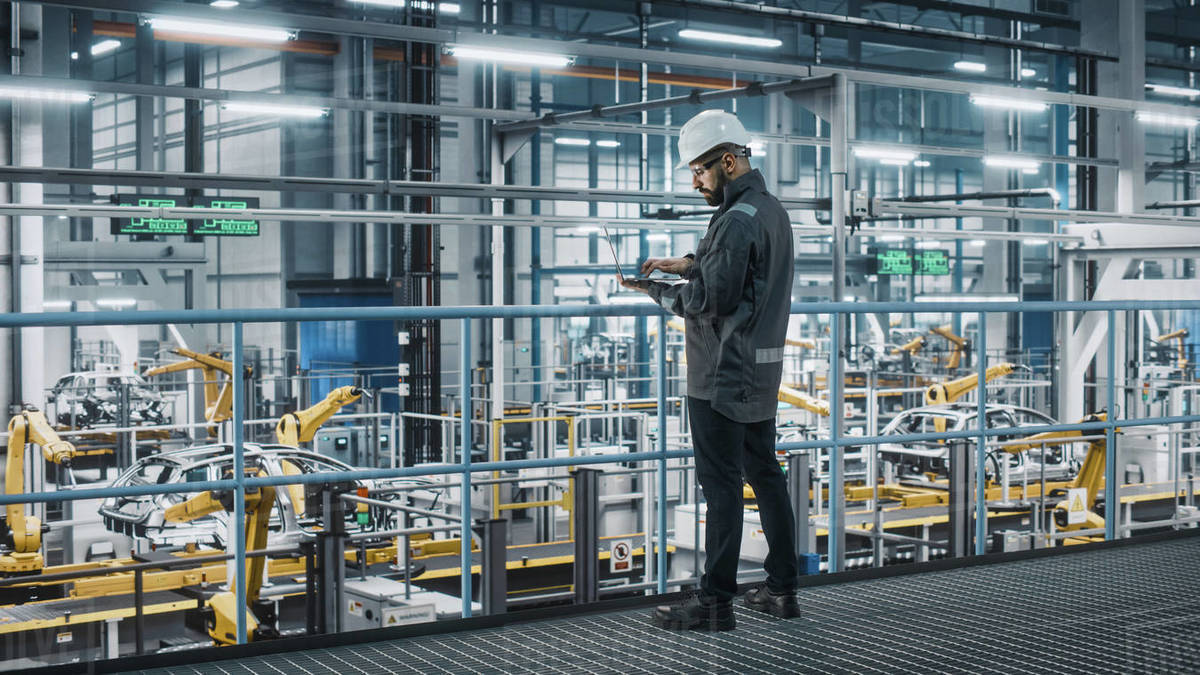 Car Factory Engineer in Work Uniform Using Laptop Computer - Royalty ...