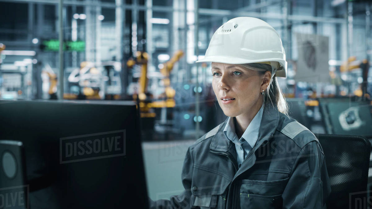 Portrait of Confident Female Chief Engineer Wearing Hard Hat Working on ...