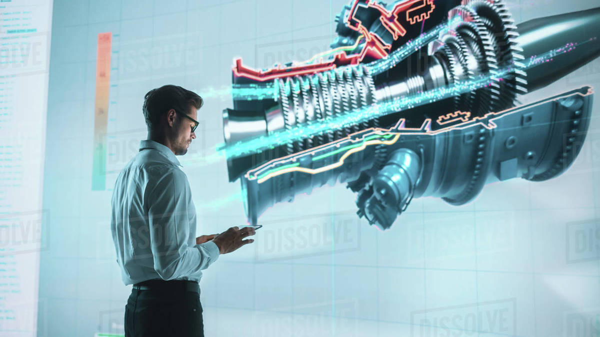 Engineer Designing Engine Using Tablet Computer and Big Wall Screen to ...