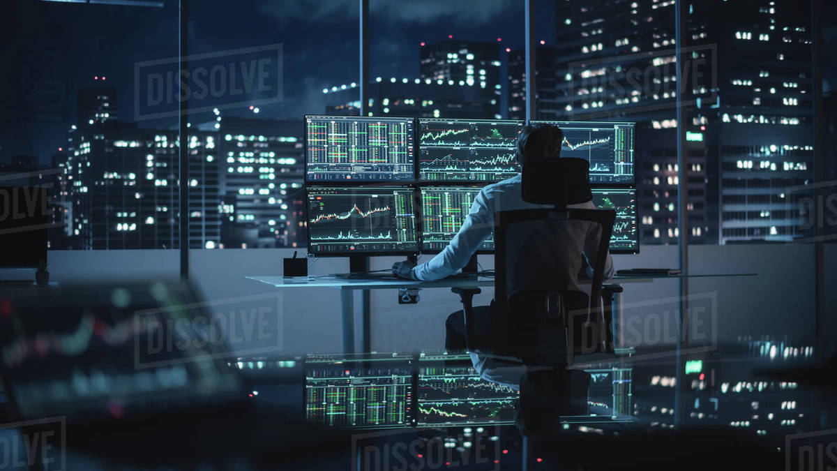 Financial Analyst Working on Computer with Multi-Monitor Workstation ...