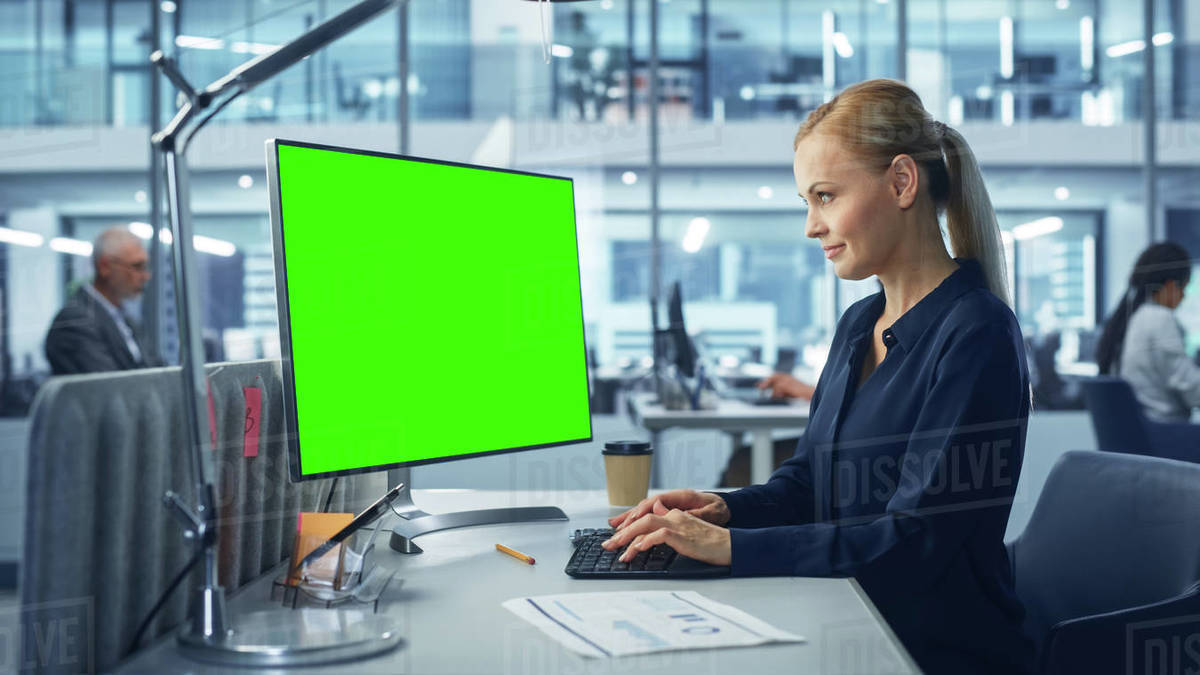 Businesswoman Using Desktop Computer with Green Screen Mock Up Display ...