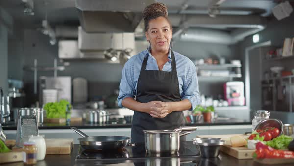 TV Cooking Show in Restaurant Kitchen: Portrait of Black Female Chef ...