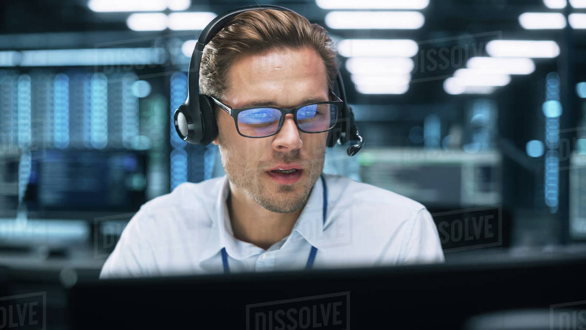 Call Center Worker Wearing Headset Working in Office to Support Remote ...