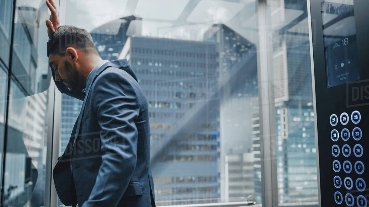 Stressed Out Manager Going Down from Office in a Glass Elevator in ...