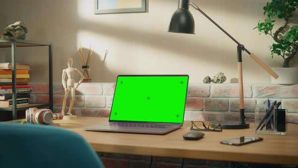 Laptop Computer Standing on a Wooden Desk with a Green Screen Chromakey ...