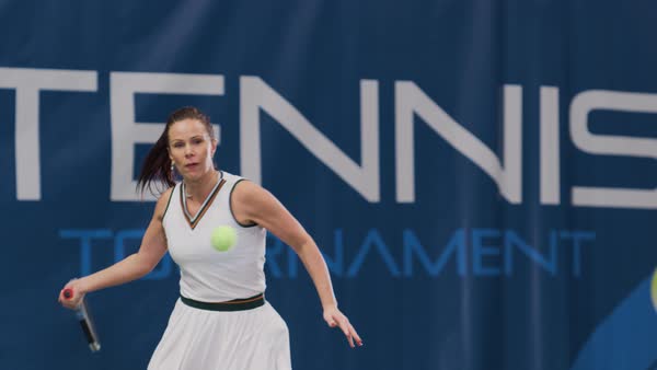 Female Tennis Player Hitting Ball with a Racquet During Championship ...