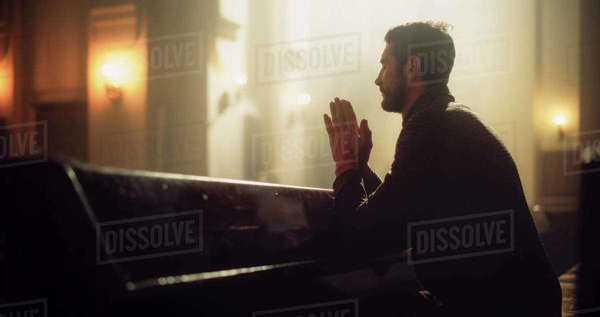 Young Christian Man Sits Piously in Majestic Church, with Folded Hands ...