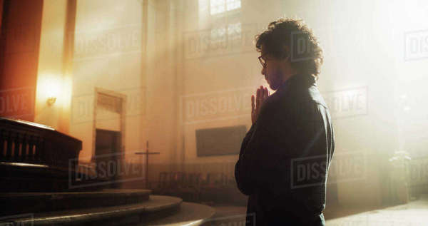 Side View: Christian Man Getting on his Knees and Starting to Pray in a ...