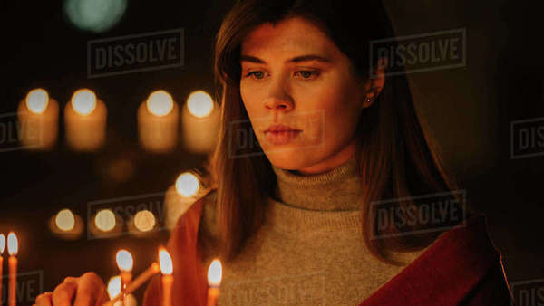 Aesthetic Shot of Young Christian Woman Lighting a Candle in Church ...