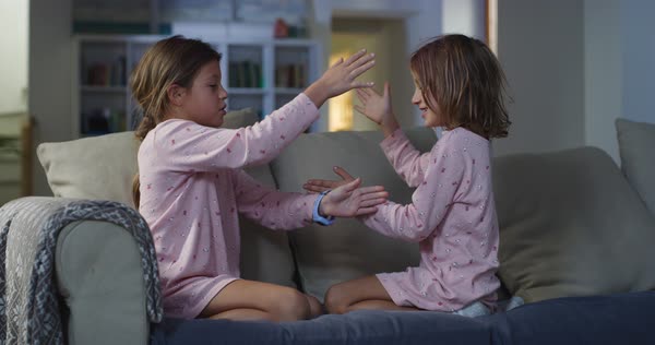 Portrait of Two Female Siblings Doing a Rock-Scissors-Paper Game While ...