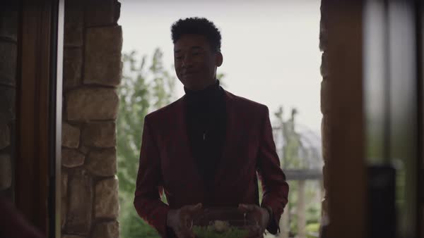 Man arriving at door carrying corsage for prom date - Stock Video ...