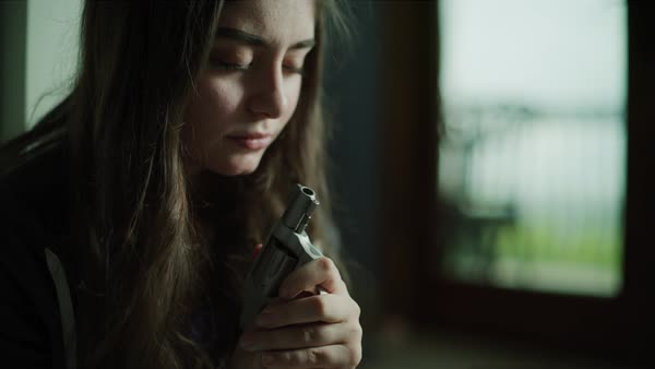 Close up of girl pointing handgun at chin then crying - 4K Rights ...