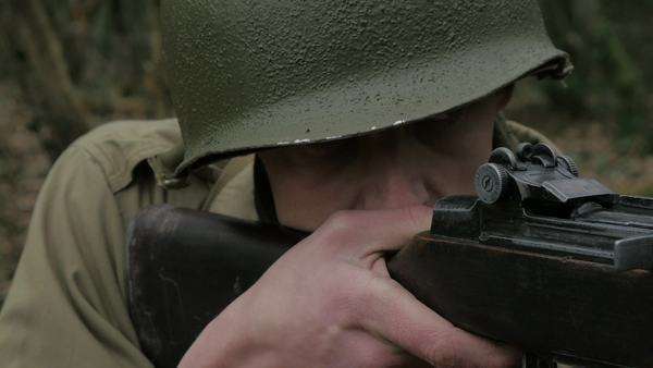 Reenactment of WW2 American infantry soldier aiming his Grand Rifle ...