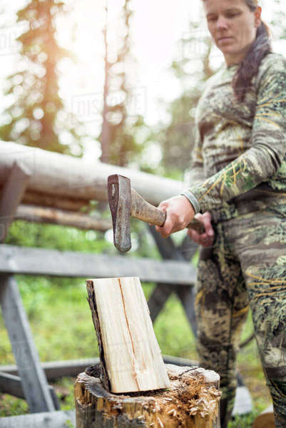 Woman chopping wood - Royalty-free Stock Photo | Dissolve