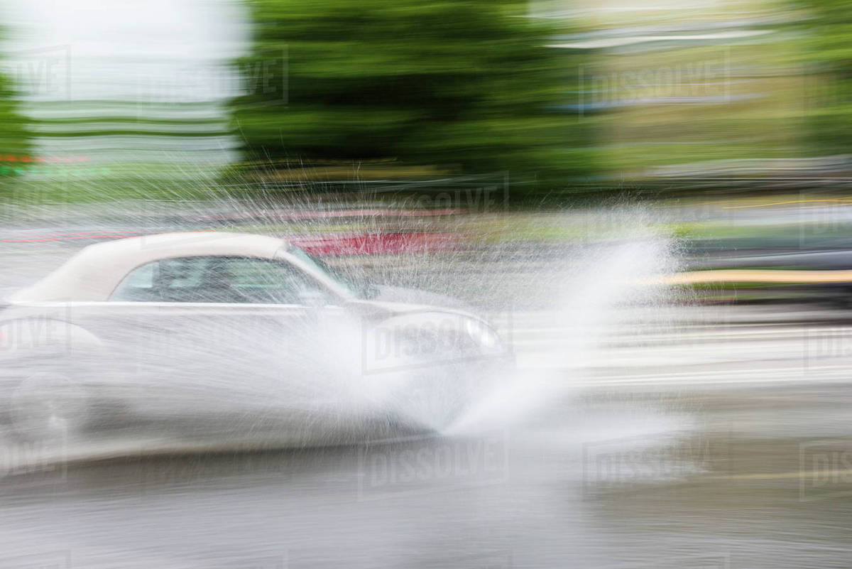 Car splashing water on road - Royalty-free Stock Photo | Dissolve