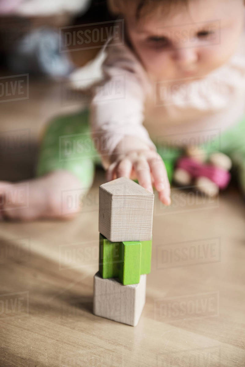 Wooden blocks, baby on background - Stock Photo - Dissolve