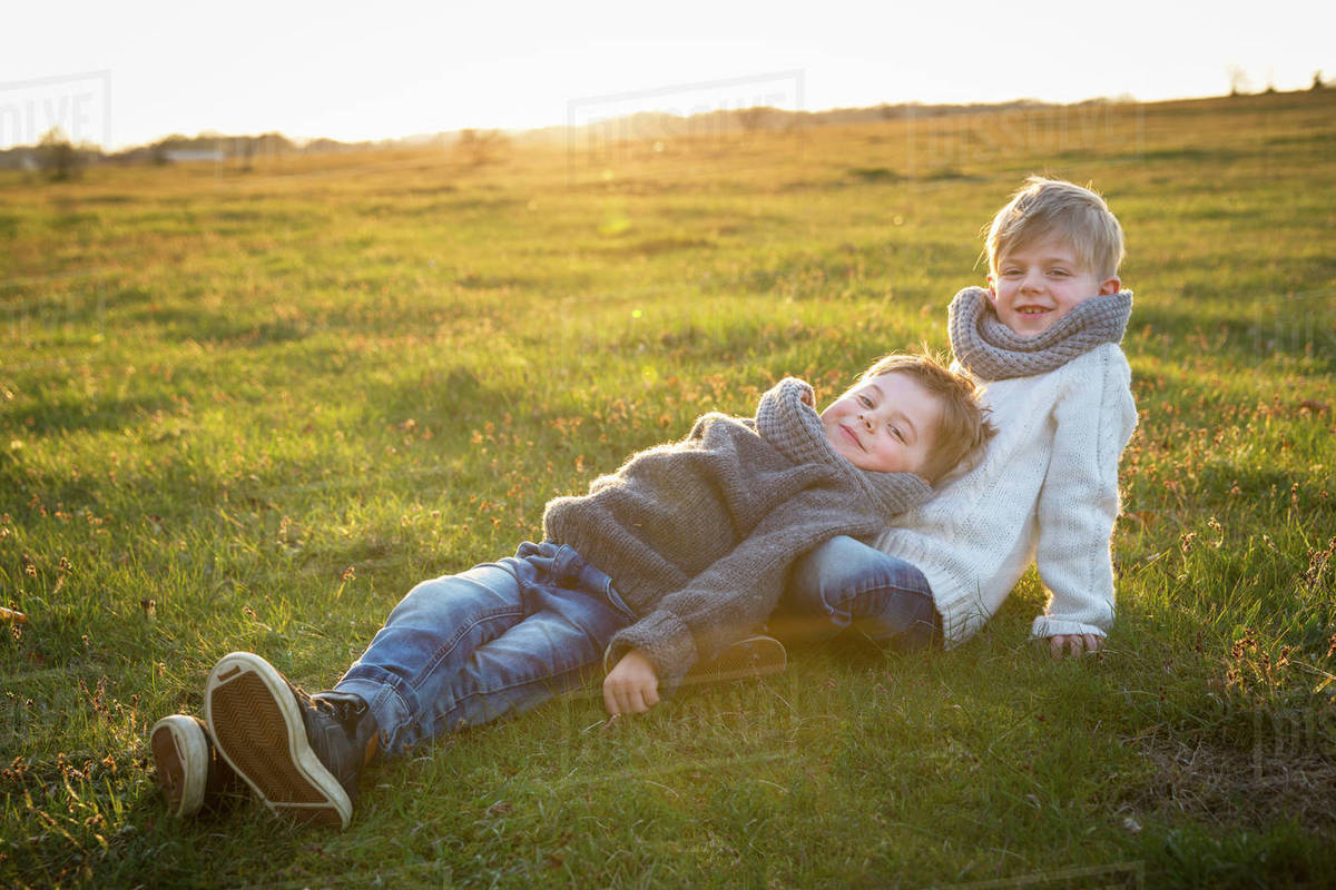 Smiling boys together on meadow - Royalty-free Stock Photo | Dissolve