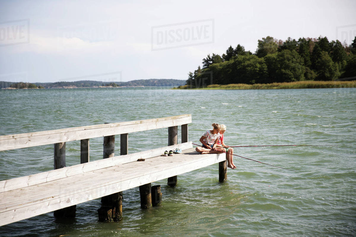 Brother and sister fishing - Stock Photo - Dissolve