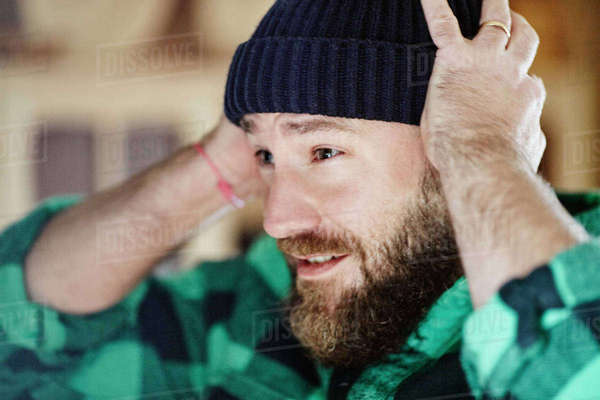 Man putting hat on - Royalty-free Stock Photo | Dissolve