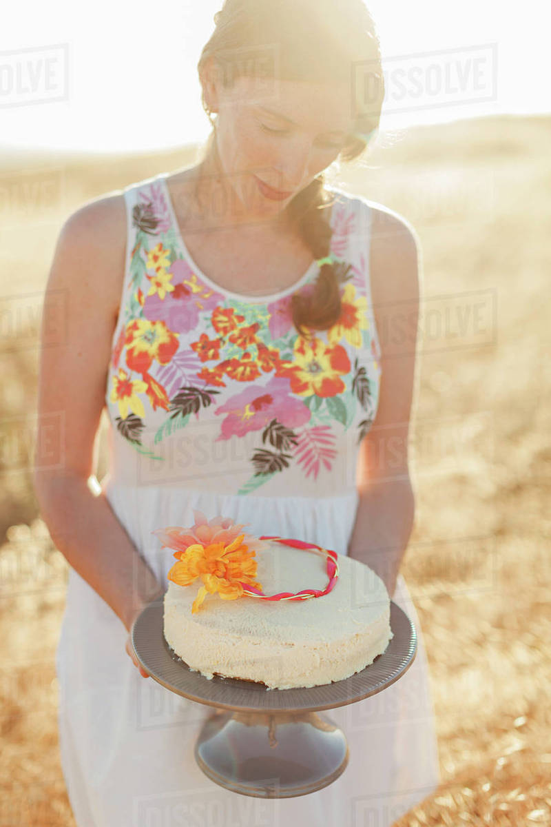 Woman holding cake - Royalty-free Stock Photo | Dissolve