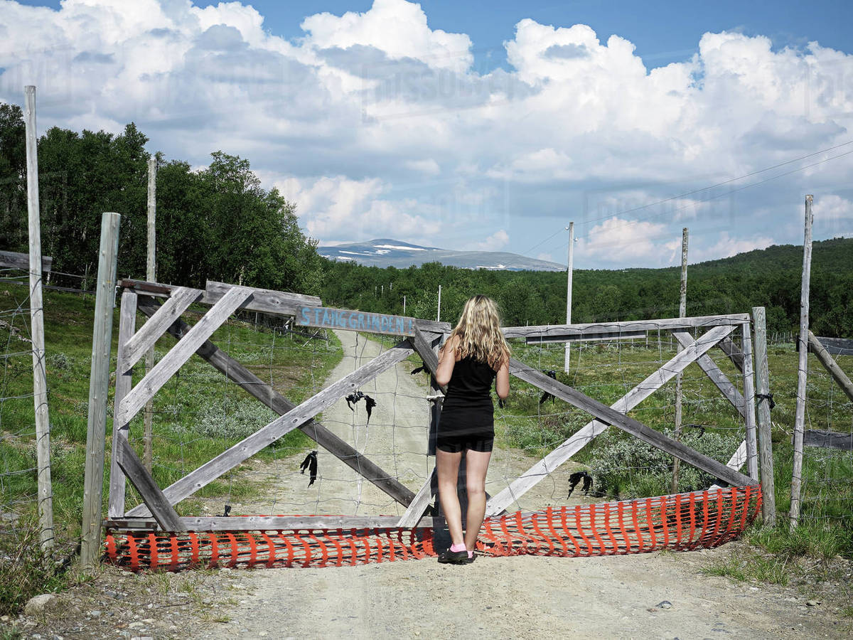 Girl looking over gate - Royalty-free Stock Photo | Dissolve