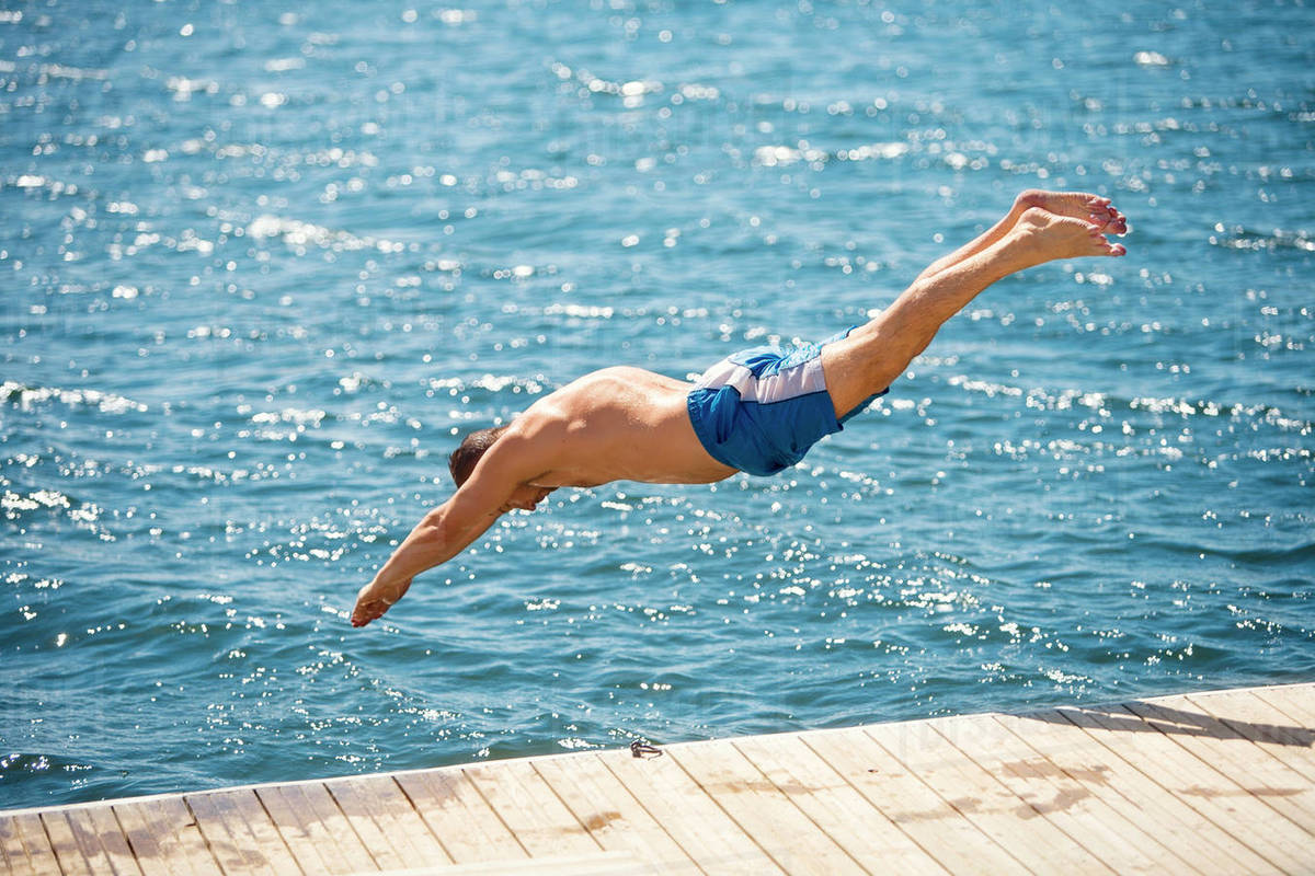 Man jumping into sea - Stock Photo - Dissolve
