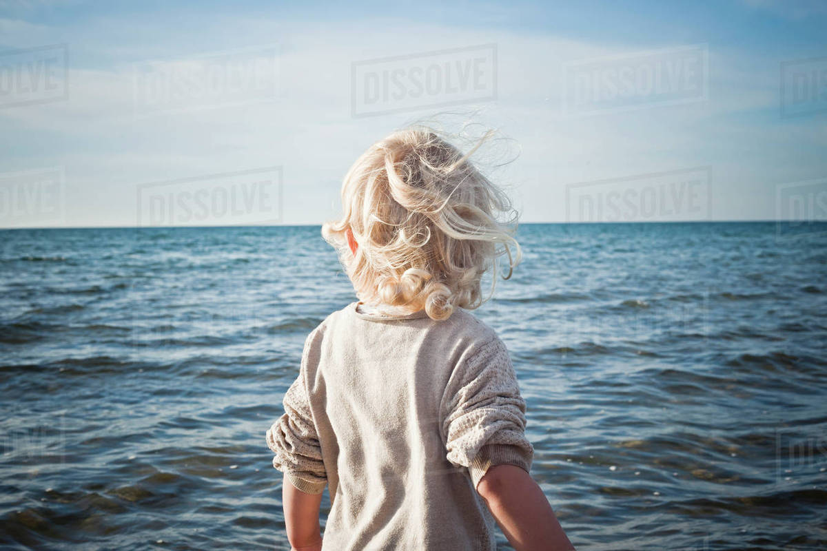 Child looking at sea - Royalty-free Stock Photo | Dissolve