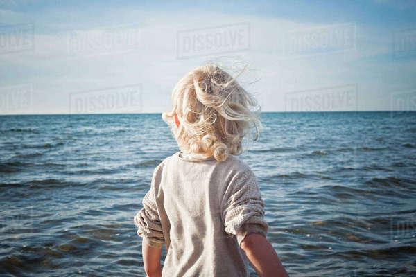 Child looking at sea - Royalty-free Stock Photo | Dissolve