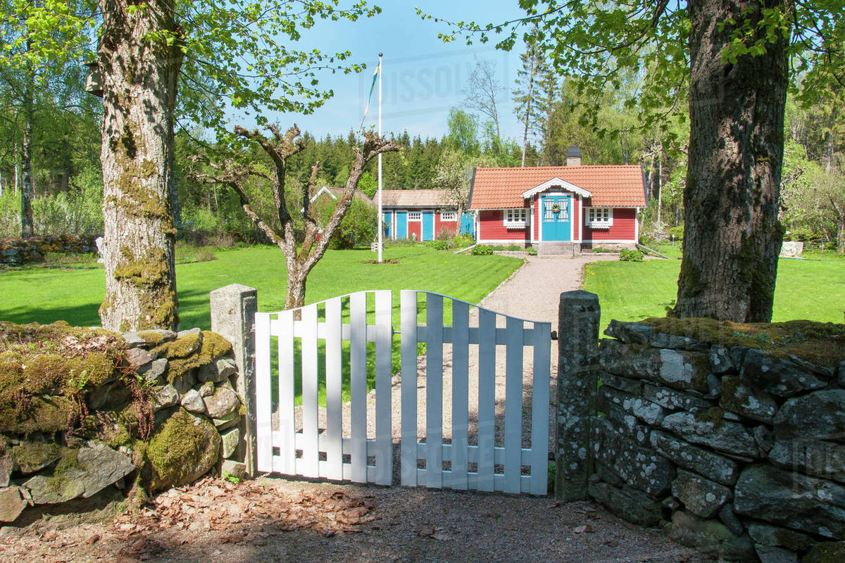 Wooden house with gate on foreground - Stock Photo - Dissolve