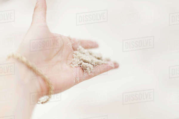 Womans hand holding sand - Royalty-free Stock Photo | Dissolve