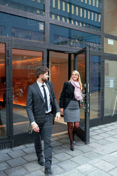 Business people leaving office building - Royalty-free Stock Photo ...