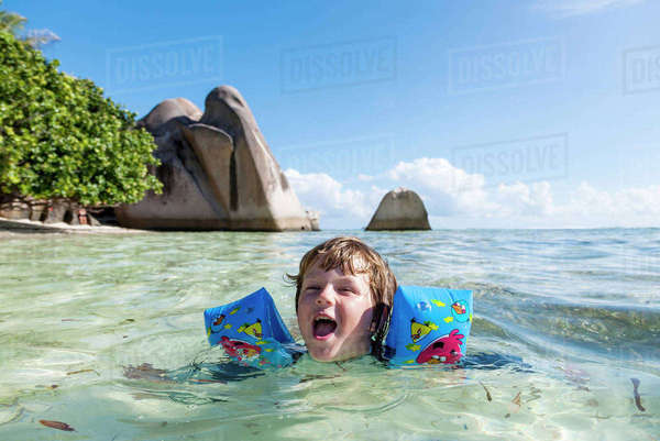 Happy boy swimming in sea - Royalty-free Stock Photo | Dissolve