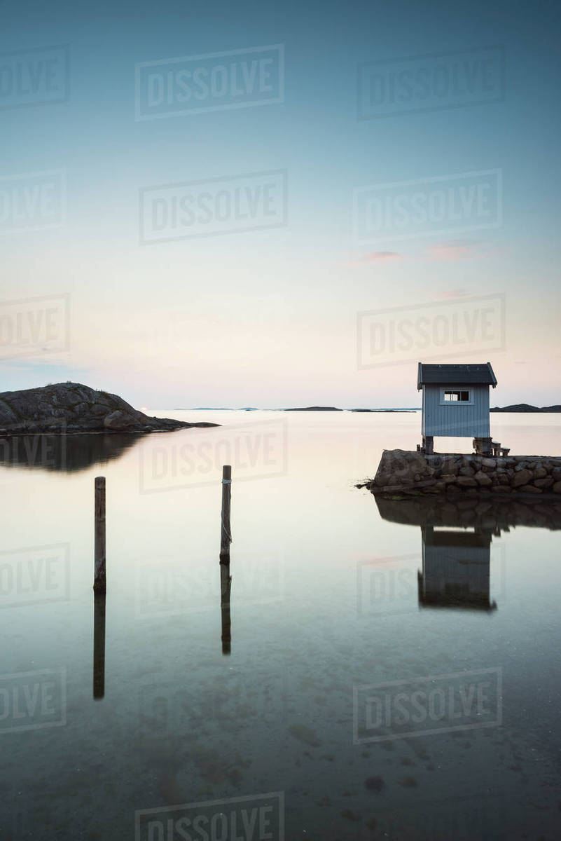 Built structure on jetty at dusk - Stock Photo - Dissolve