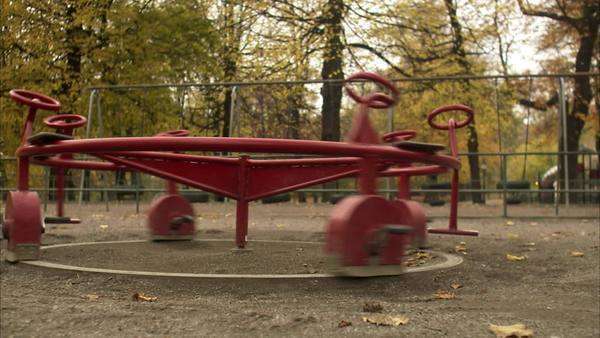 A roundabout in a playground, Sweden. - Stock Video Footage - Dissolve