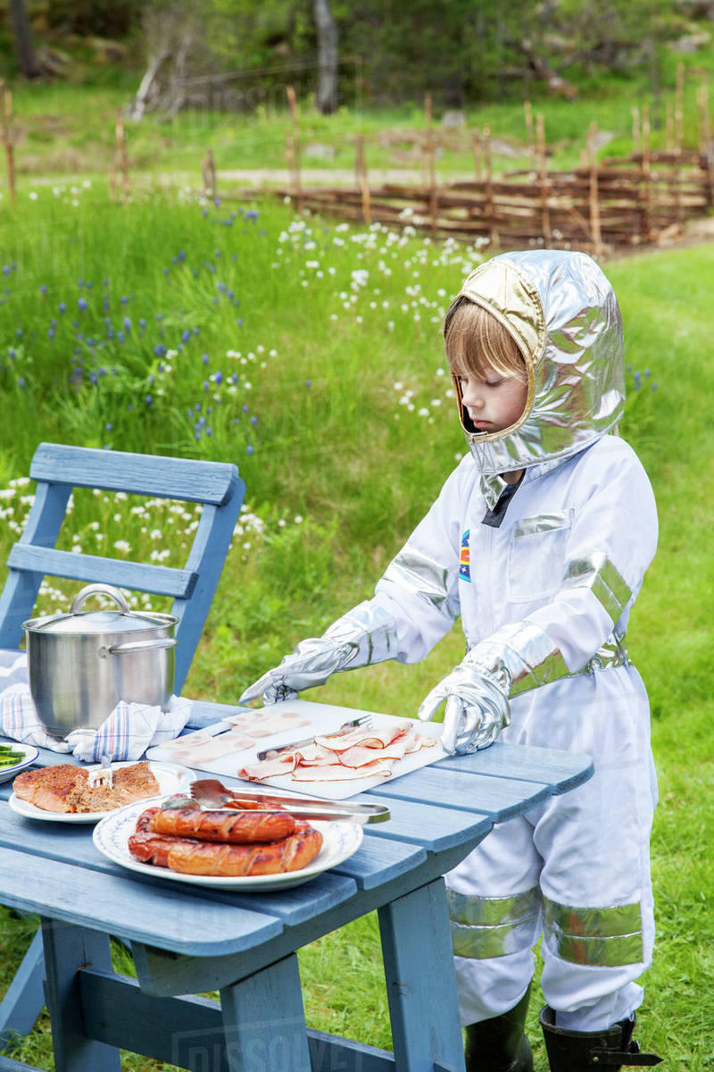 Girl in costume holding tray with food - Stock Photo - Dissolve