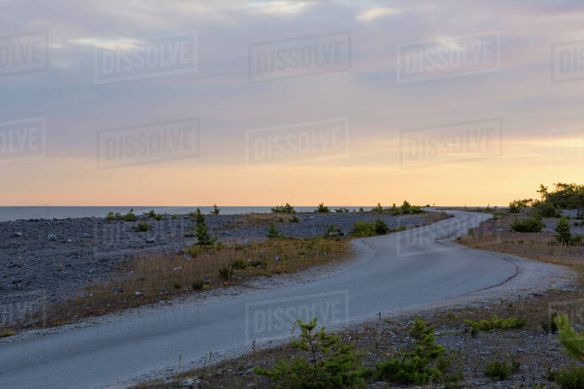 Empty road at sunset - Royalty-free Stock Photo | Dissolve