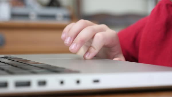 A cute little boy using the computer to do his preschool learning ...