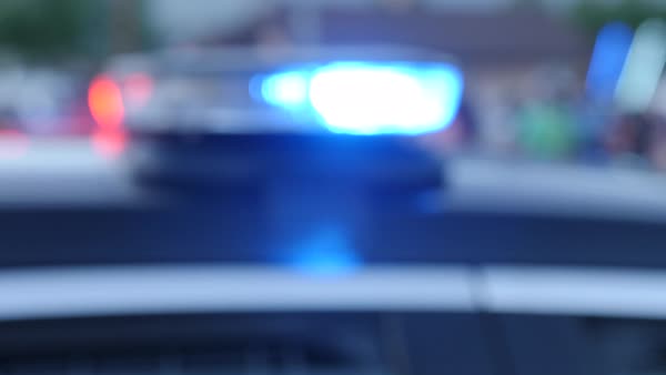 Red and blue flashing police lights and emergency vehicles at a crime ...