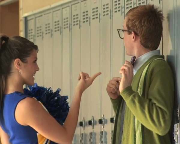 Cheerleader hitting on nerd - Stock Video Footage - Dissolve