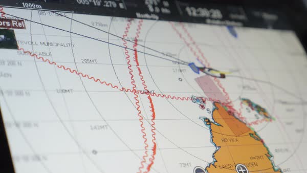 Boat moving on the dashboard GPS navigator. Tracking the route of sea ...