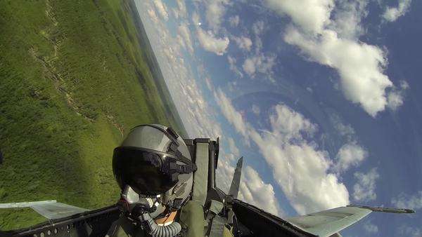 A pilot or passenger is shown flying in a F18 fighter plane, the clouds ...