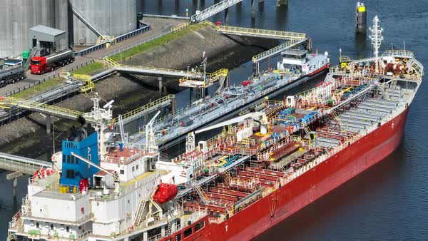 Liquid Cargo Transporter Ship Unloading Crude Oil to a Fuel Depot ...