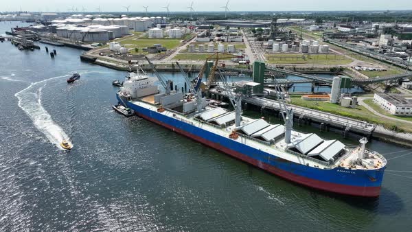 Bulk Carrier Ship at Port Offloading Cargo and Commodities by Shore ...