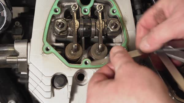 Measurement and adjustment of valve clearances in a motorcycle engine ...